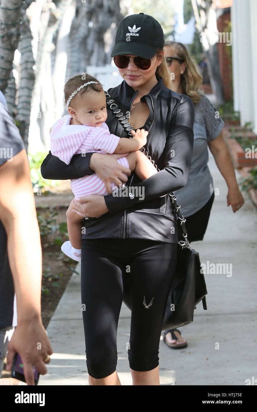 Chrissy Teigen and John Legend shop at The Row with their daughter Luna ...