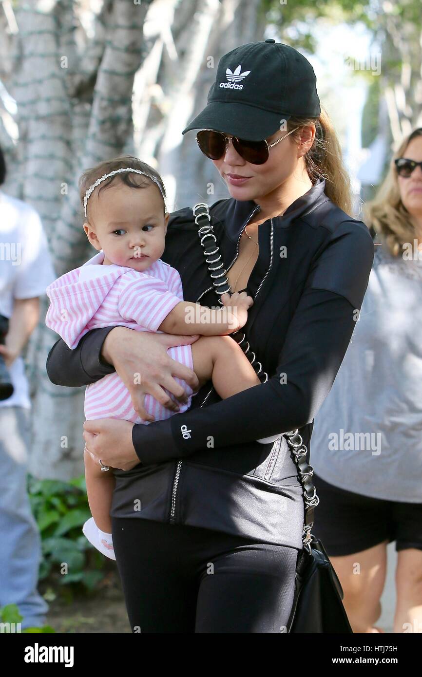 Chrissy Teigen and John Legend shop at The Row with their daughter Luna ...
