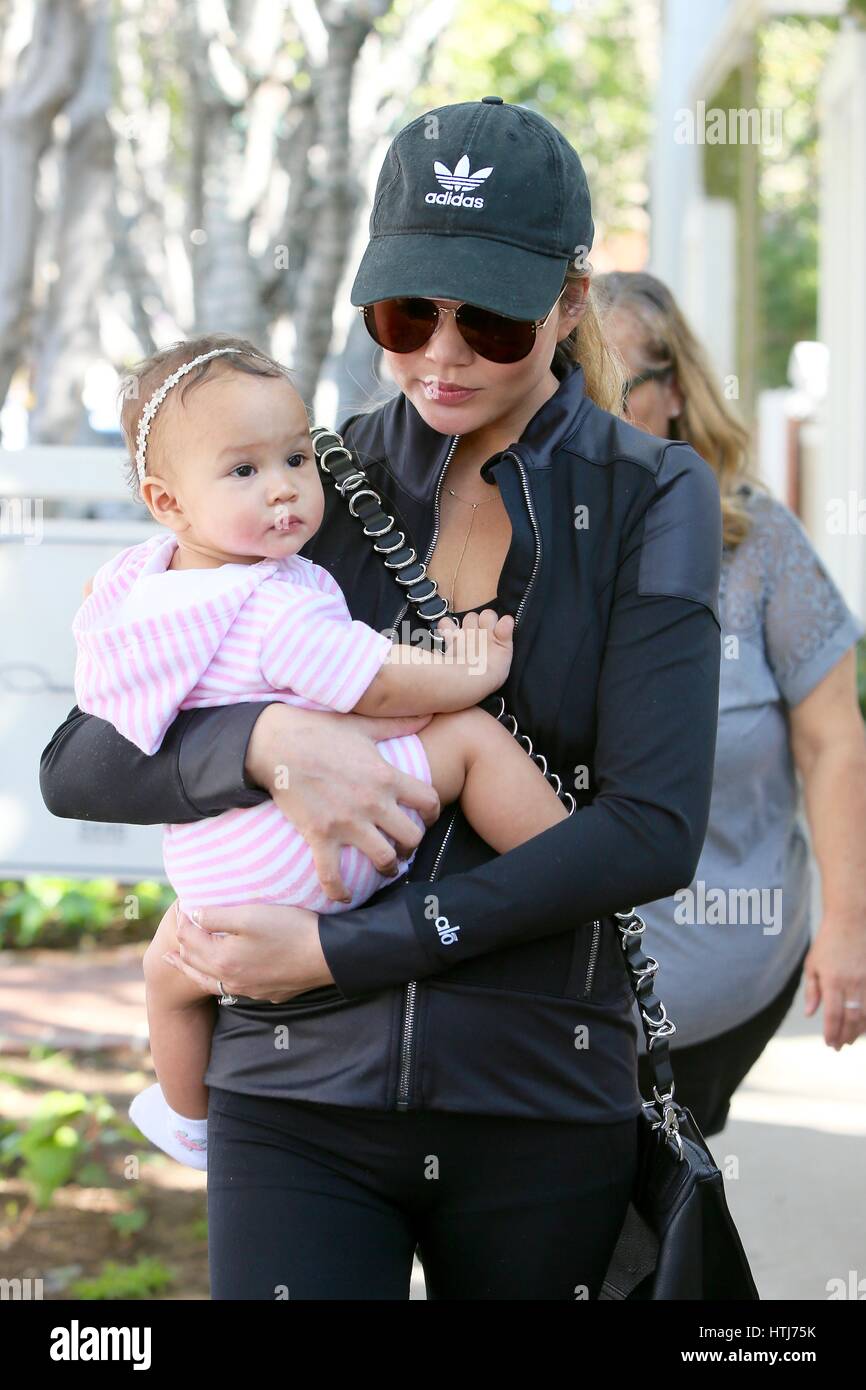 Chrissy Teigen and John Legend shop at The Row with their daughter Luna ...