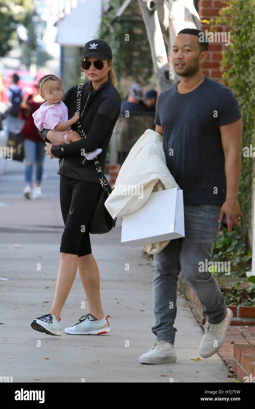 Chrissy Teigen and John Legend shop at The Row with their daughter Luna ...