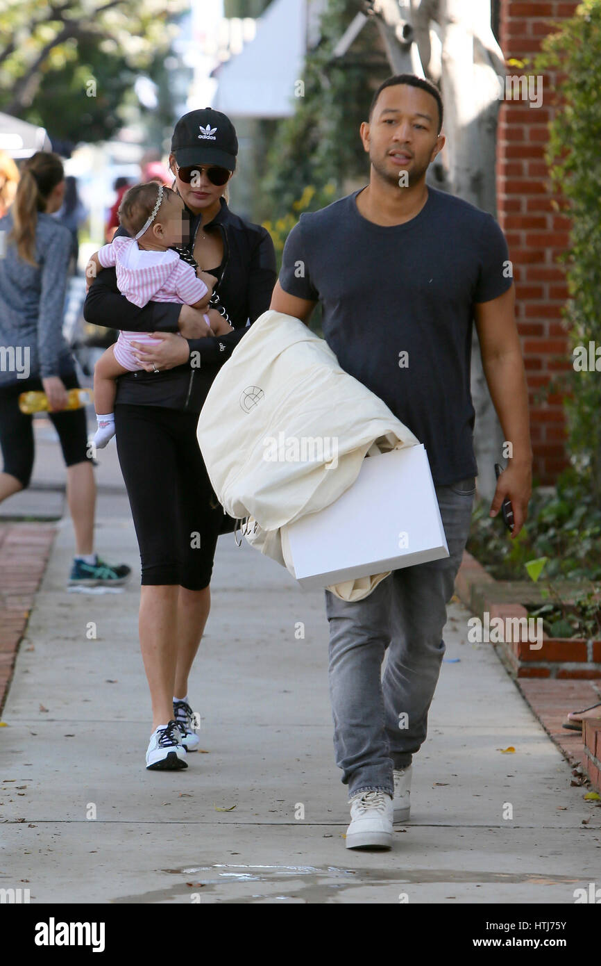 Chrissy Teigen and John Legend shop at The Row with their daughter Luna ...