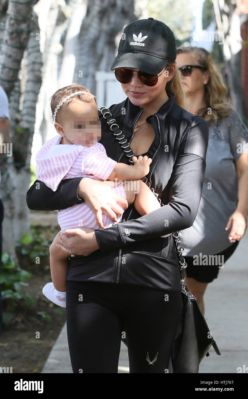 Chrissy Teigen and John Legend shop at The Row with their daughter Luna ...