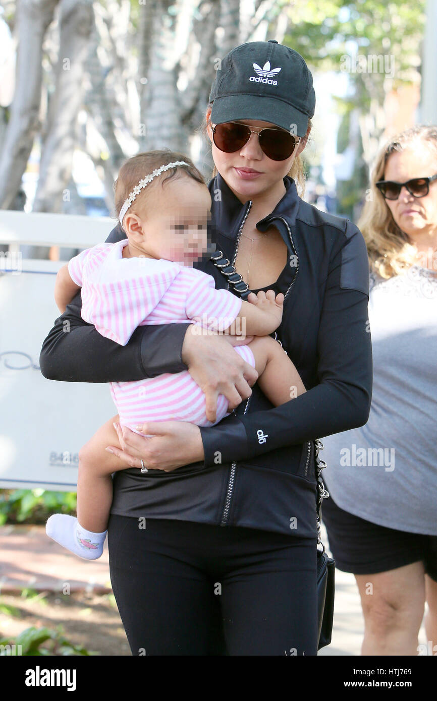 Chrissy Teigen and John Legend shop at The Row with their daughter Luna ...