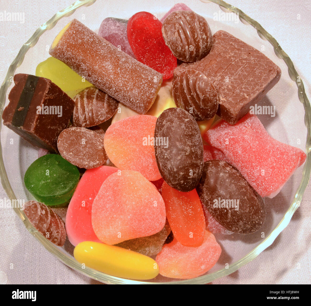Mixed candy of various colors in a glass bowl Stock Photo - Alamy