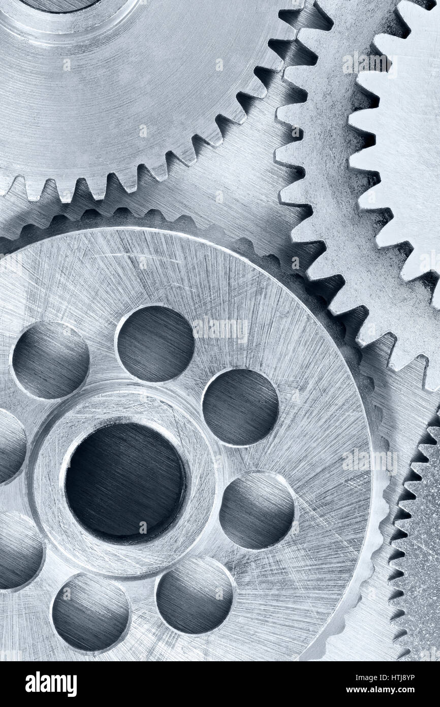 different scratched metal gear cogwheels on industrial background Stock ...
