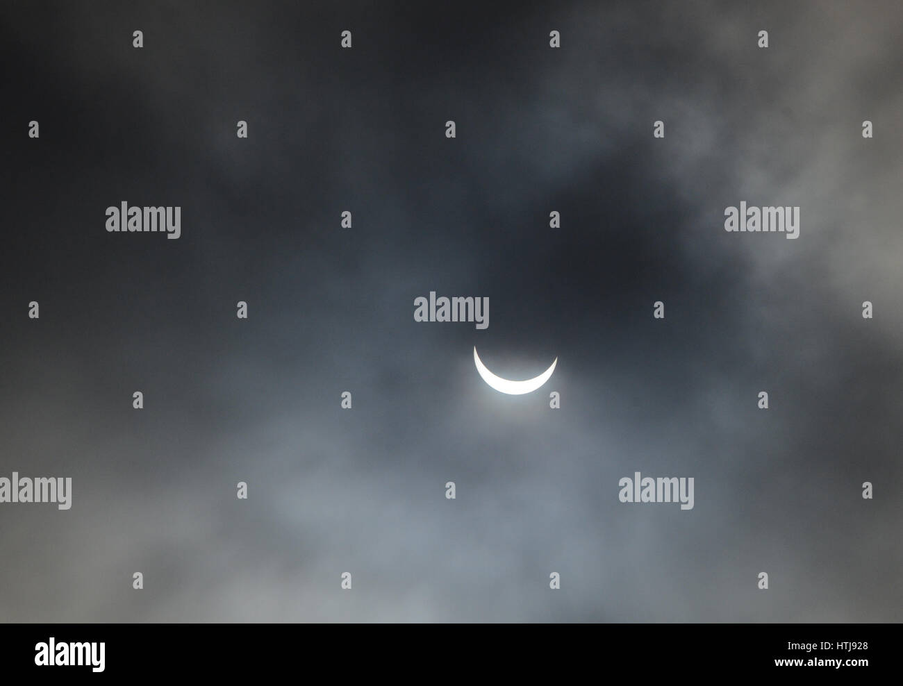 Partial solar eclipse seen trough a layer of clouds Stock Photo - Alamy