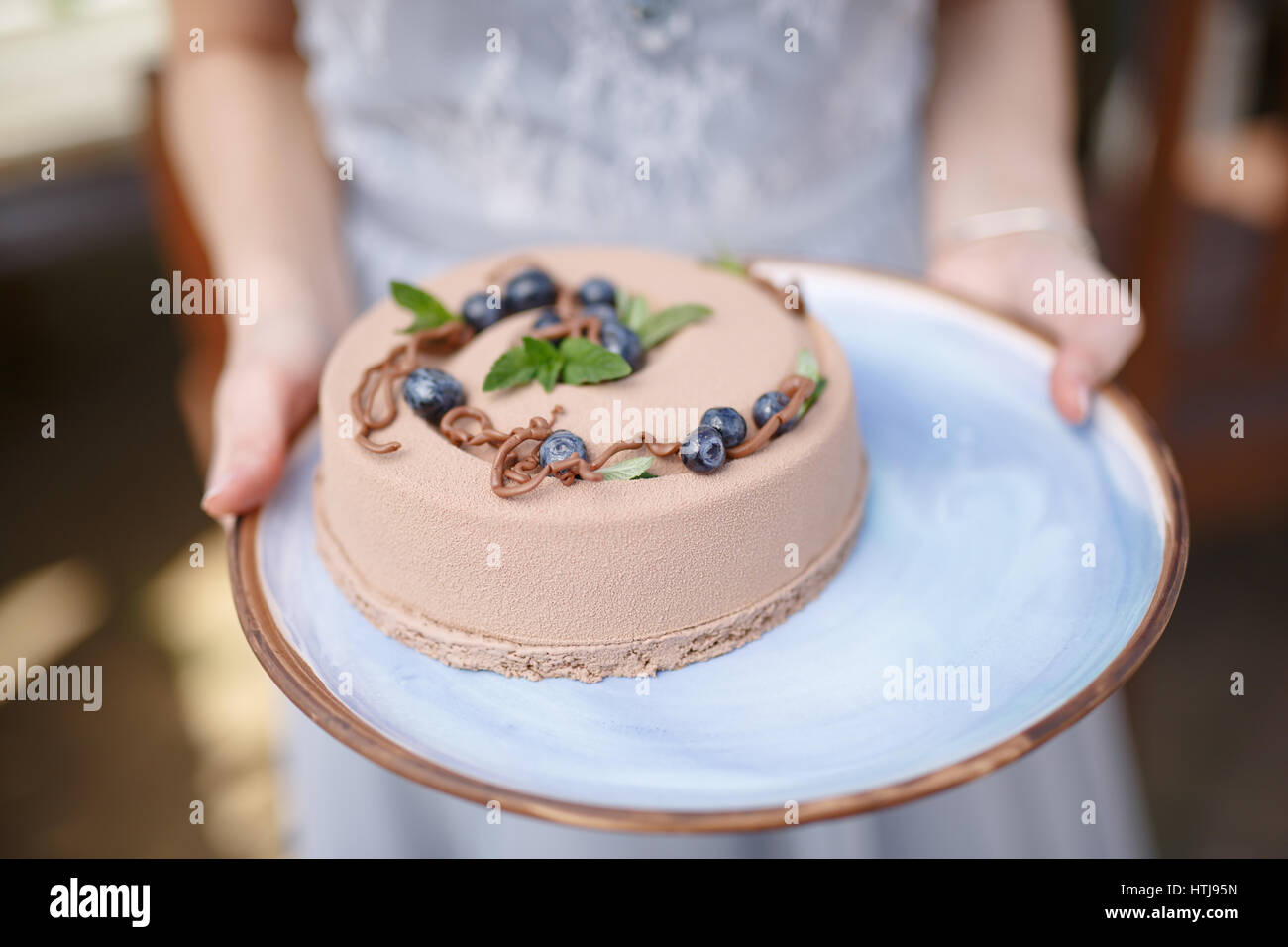 Baker hands holding delicious creamy cake closeup Stock Photo - Alamy