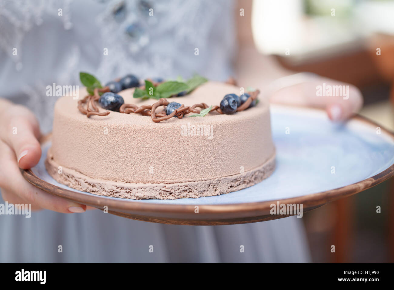 Baker hands holding delicious creamy cake closeup Stock Photo - Alamy