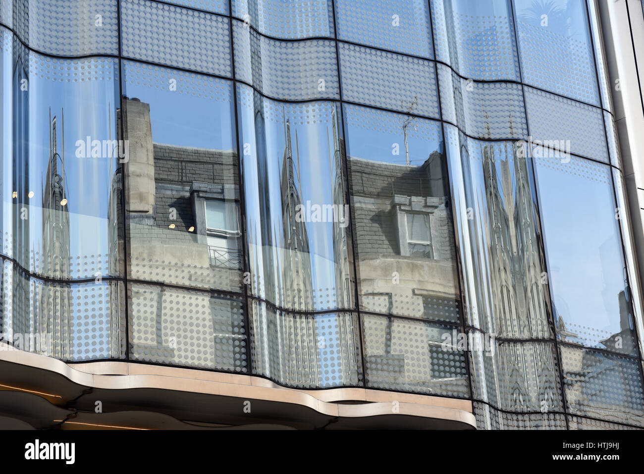 A glass fronted building in Oxford Street, London, reflecting the ...