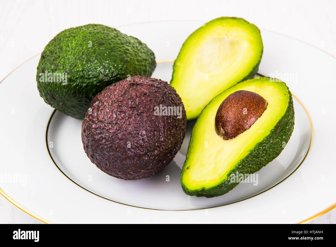 Avocado whole and cut. Studio Photo Stock Photo - Alamy