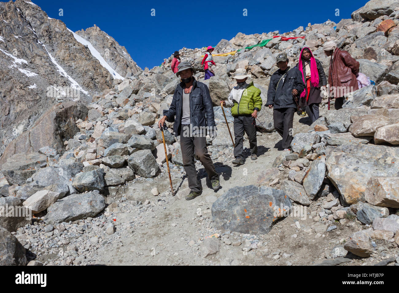 Group of Tibetan Buddhist pilgrims descending from Dolma La pass en ...