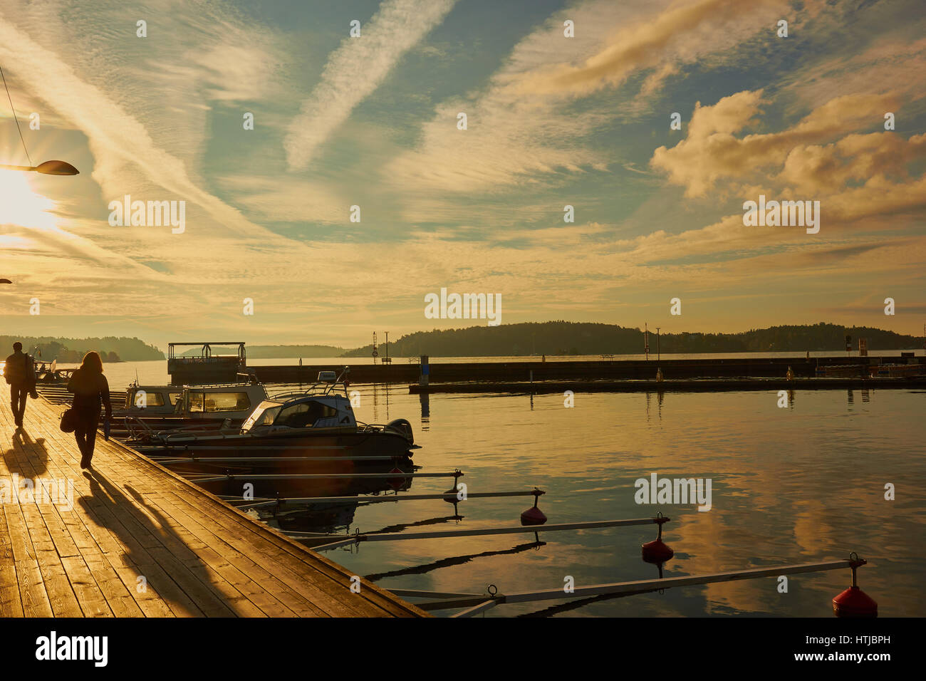 Golden sunrise on wooden jetty and guest harbour, Vaxholm, Stockholm ...
