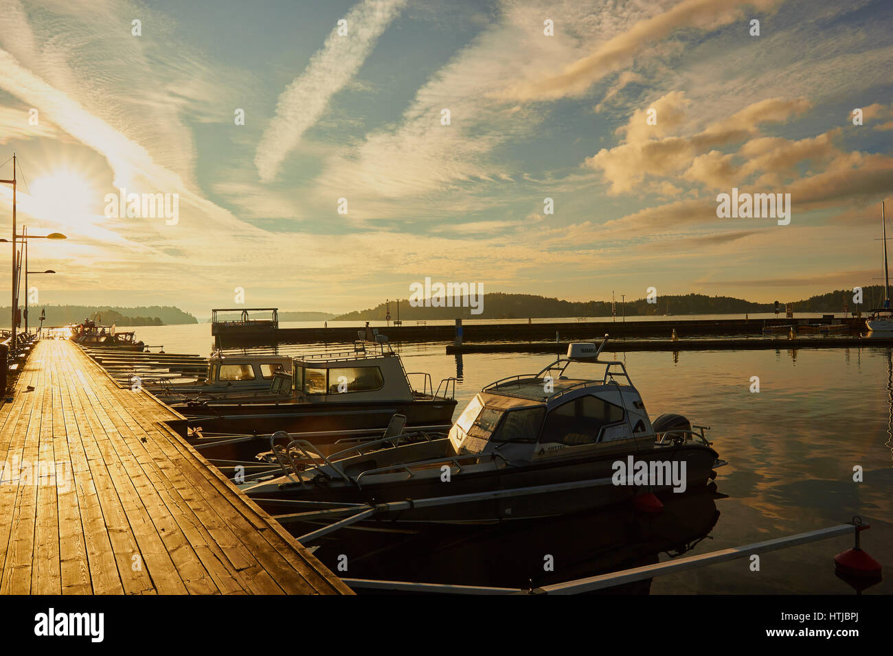 Golden sunrise on jetty and guest harbour, Vaxholm, Stockholm ...