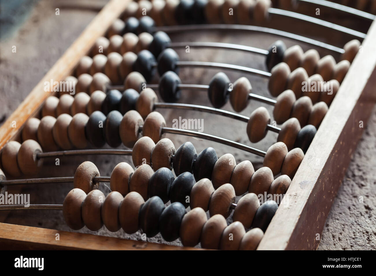 Vintage abacus lay on stone table, close up photo with selective focus ...