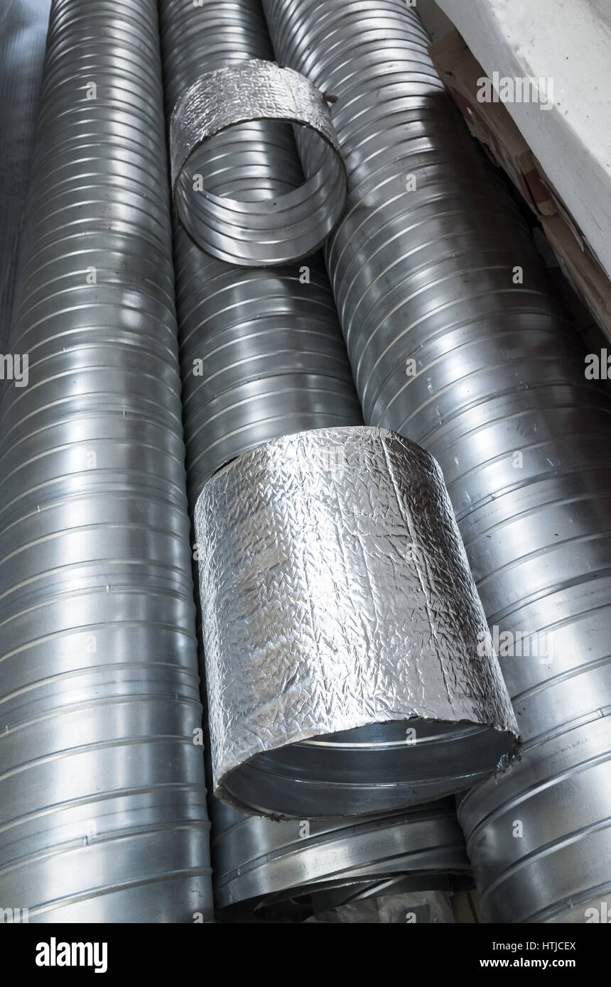 Group of shiny metallic tubes for air ventilation systems, vertical ...