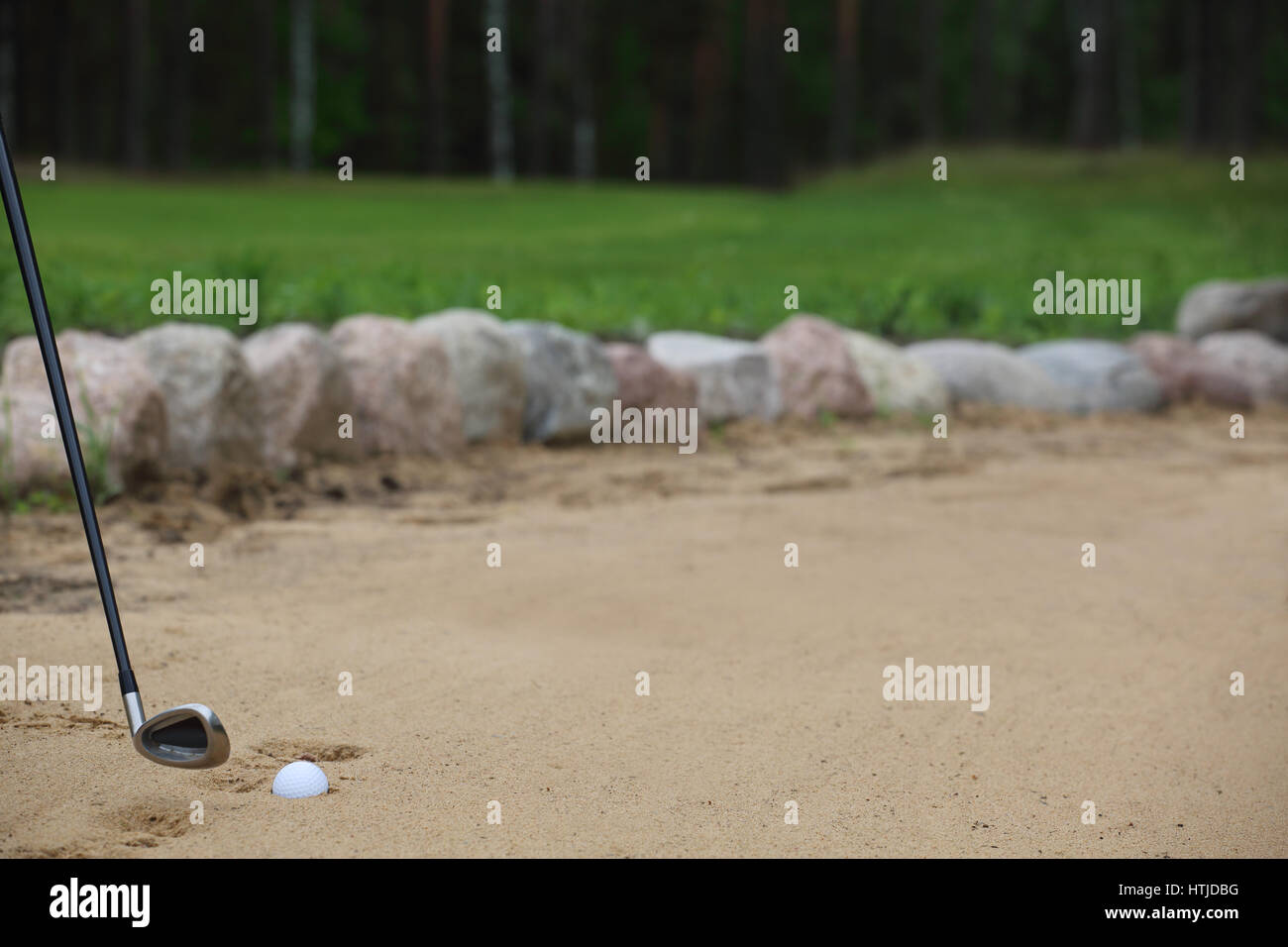 Golf ball and club in sand bunker at golf course Stock Photo - Alamy