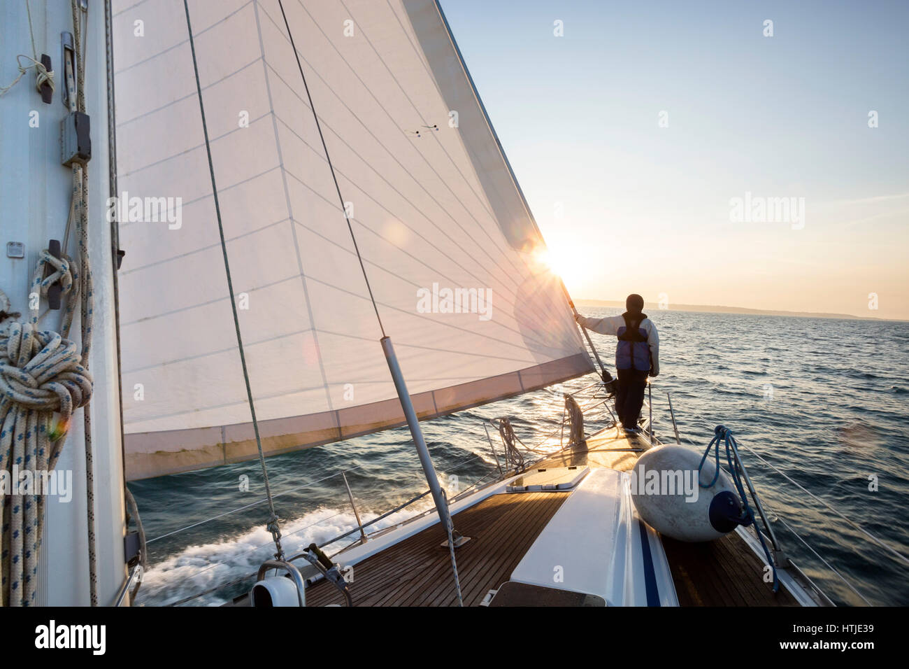 Man Standing On The Front Of Sail Boat In Sea Stock Photo - Alamy