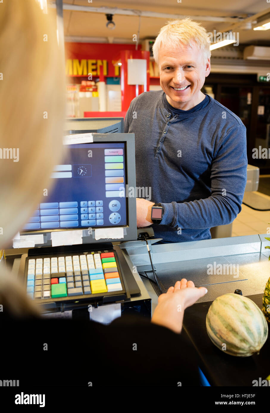 Customer Paying Through Smartwatch While Cashier Guiding Him Stock ...