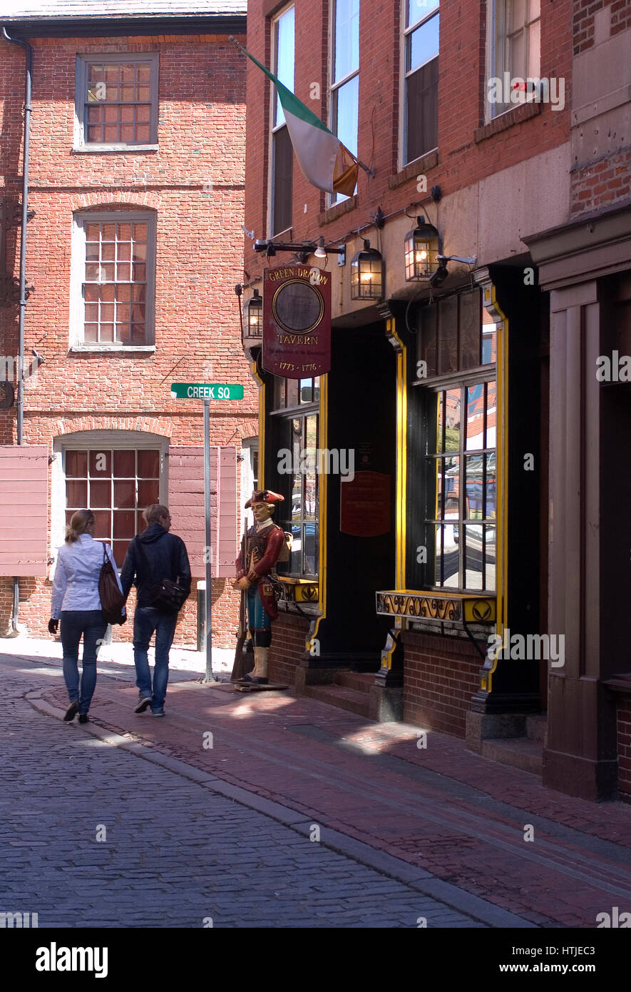 A couple strolls along Marshall Street in downtown Boston, passing the ...