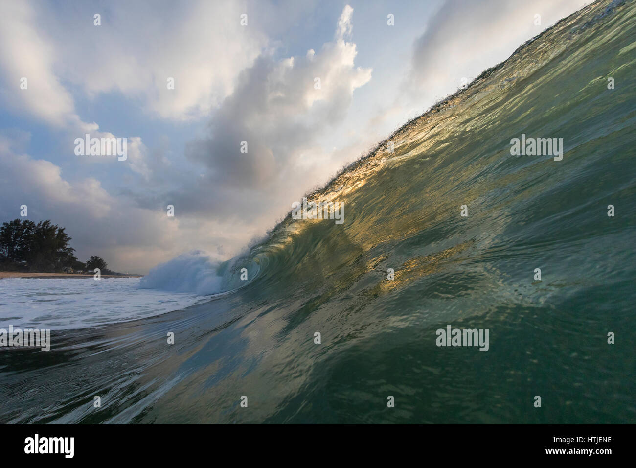 A shore break wave in moody light at Keiki beach on the North Shore of ...