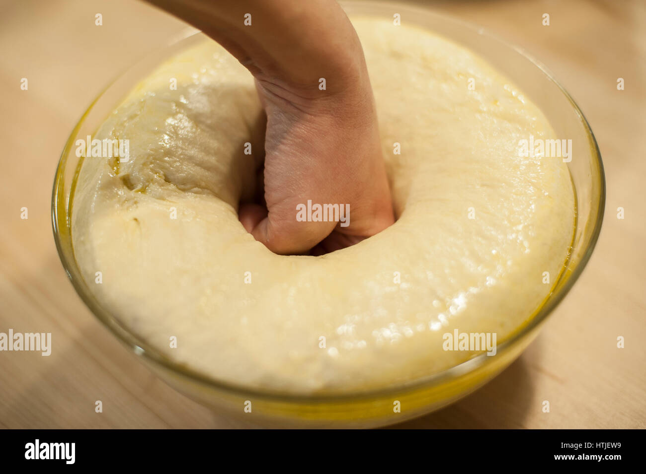 Punching Down Focaccia Dough After The First Rise Stock Photo - Alamy