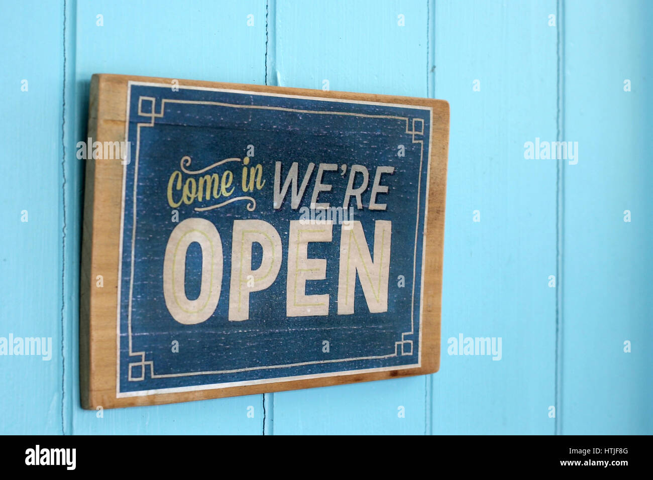 vintage open sign on blue wooden door Stock Photo - Alamy