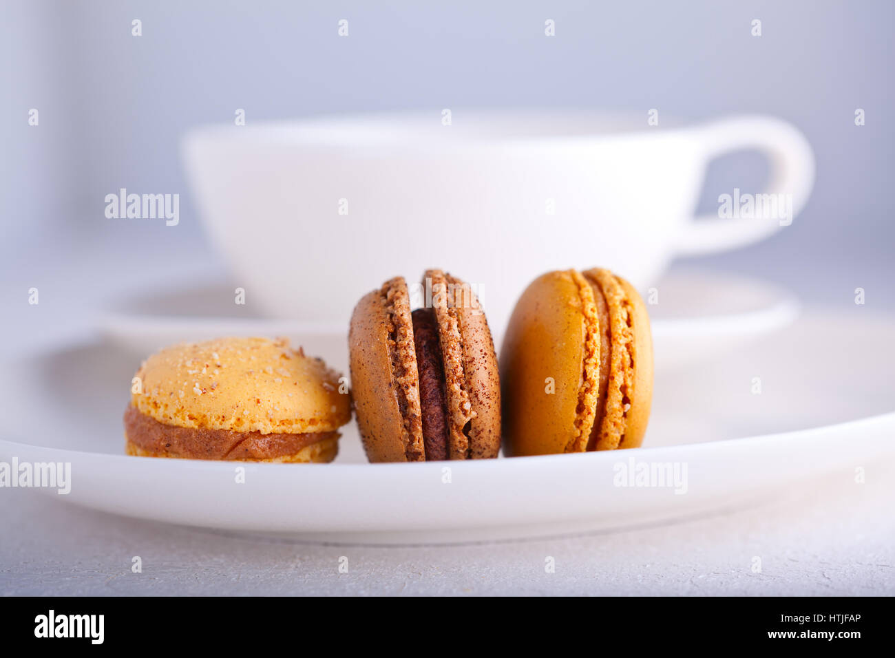 Almond cookies French macaroons with a cup of tea Stock Photo - Alamy