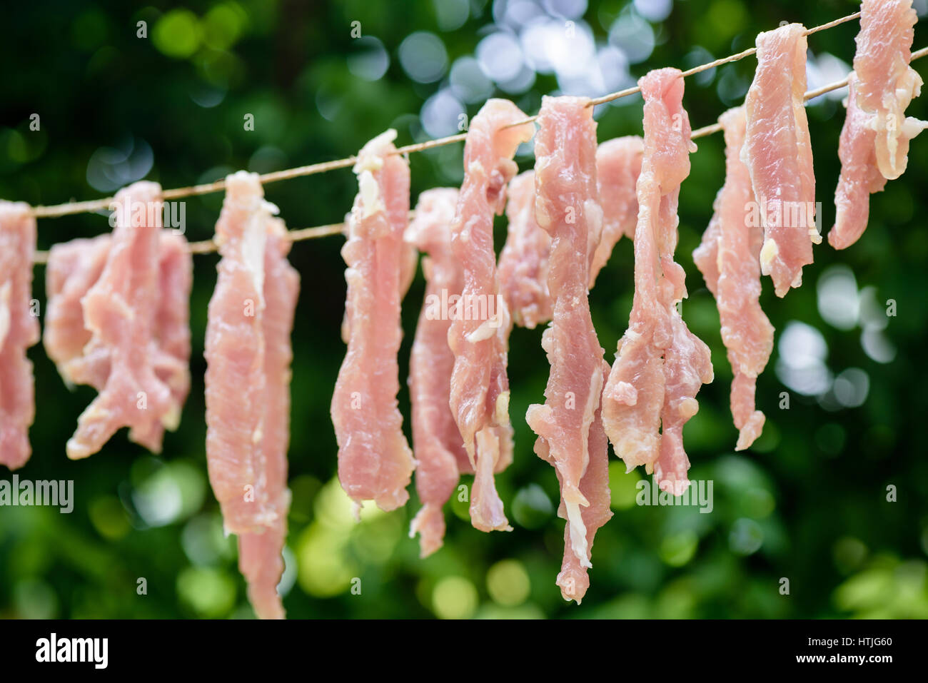 Strips of pork drying in the sun, traditional food preservation Stock ...