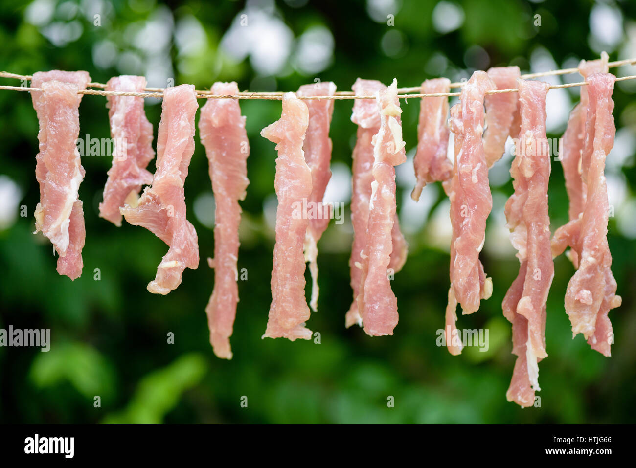 Strips of pork drying in the sun, traditional food preservation Stock ...