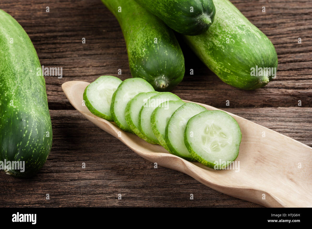 sliced fresh cucumbers in wooden bowl, healthy eating Stock Photo - Alamy