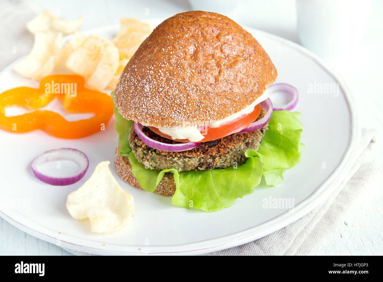 Vegetarian lentil burger with vegetables on white plate - healthy vegan ...