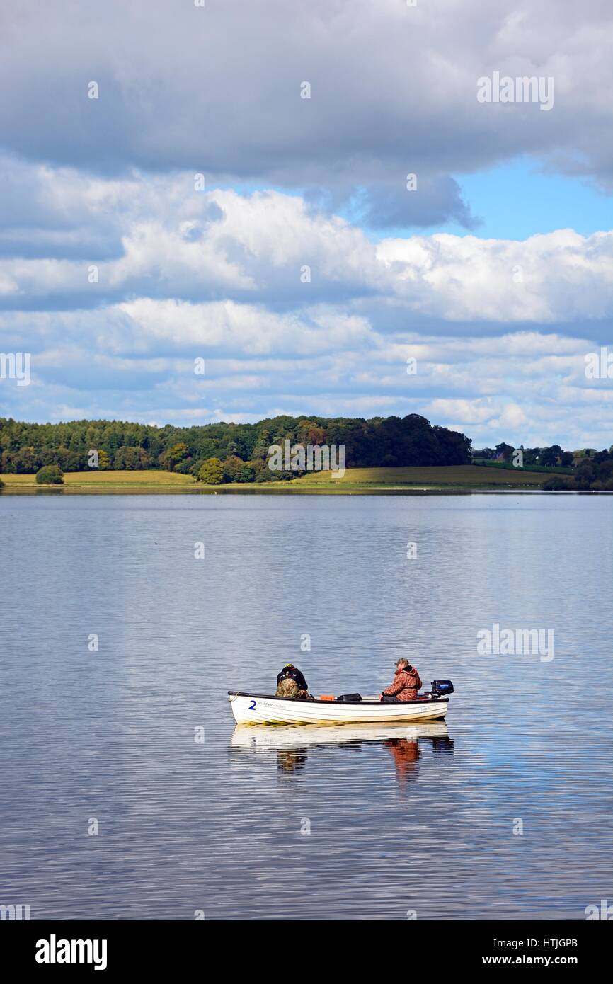Two fishermen in a small boat on Blithfield reservoir, Blithbury ...