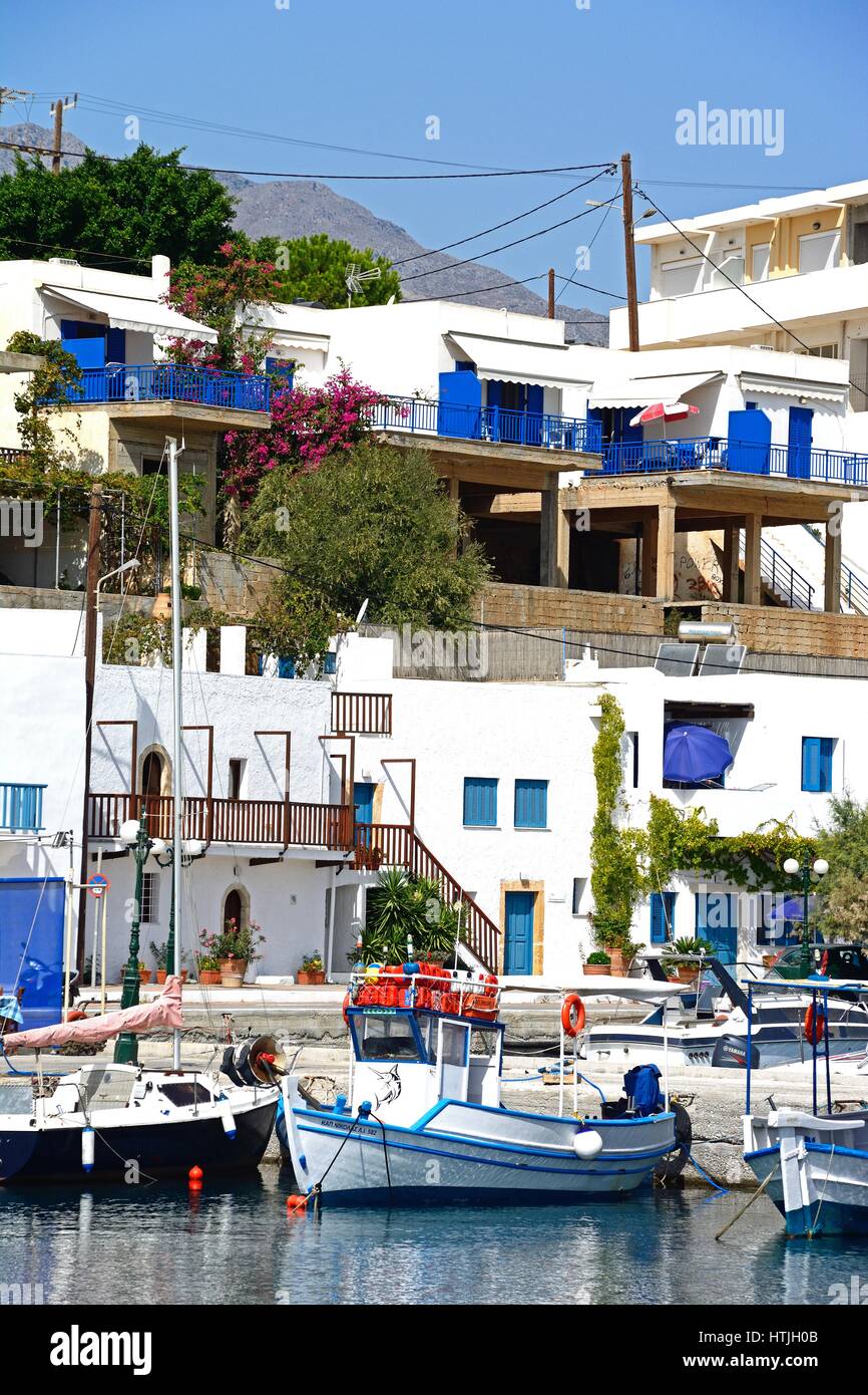 Traditional fishing boats in the harbour with town buildings to the ...
