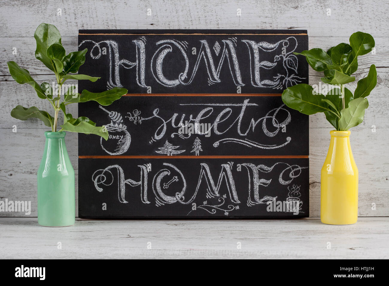 Hand lettering calligraphy sign drawn with chalk. Lettered quote 'Home ...