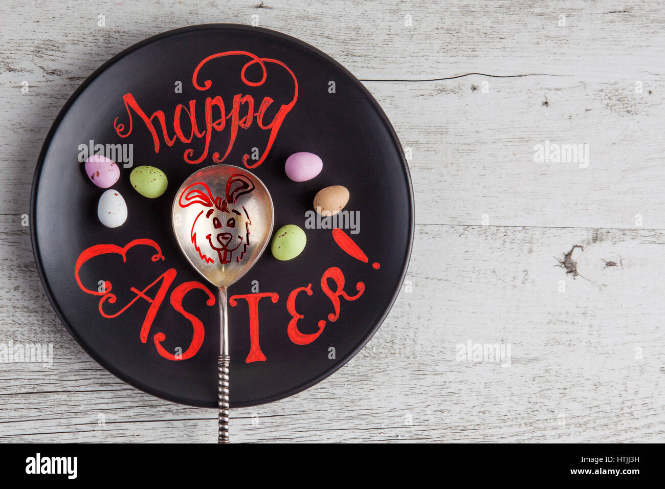 Happy Easter hand lettering quote written on black plate with Easter ...