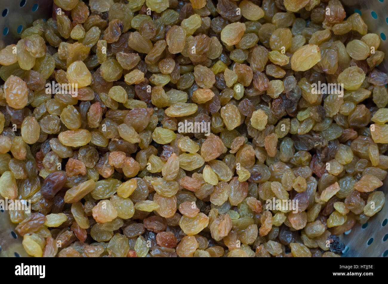 Many brown raisins background closeup top view Stock Photo - Alamy