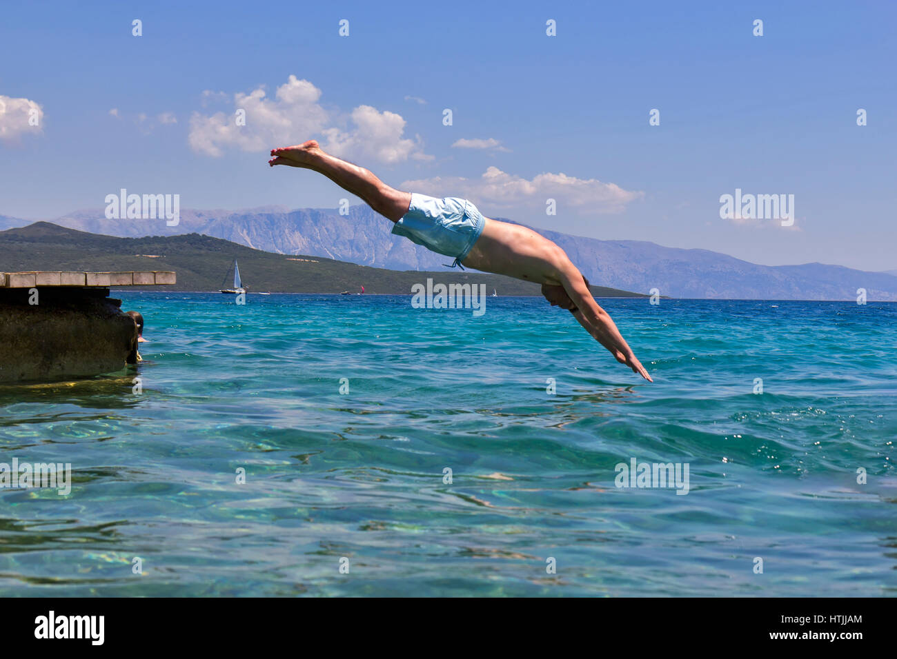 Swimmer jumping to sea water Stock Photo - Alamy