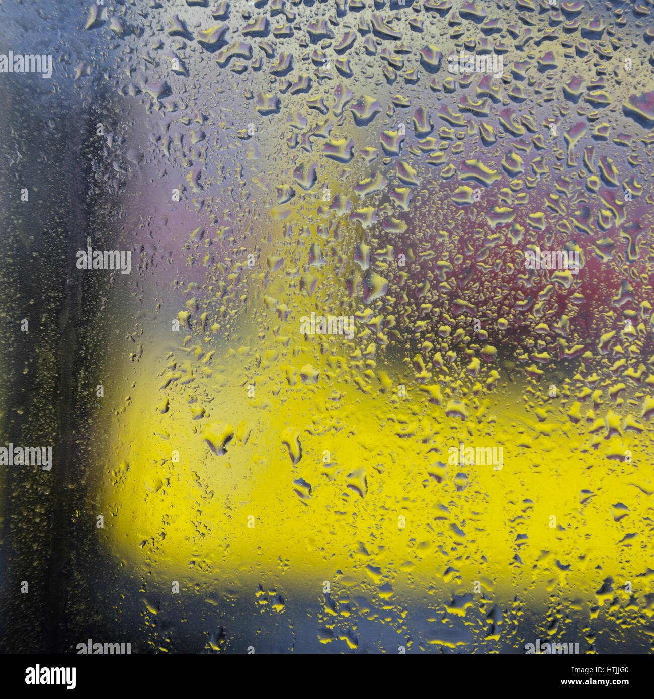 rain drops on windshield of car and yellow with red background Stock ...