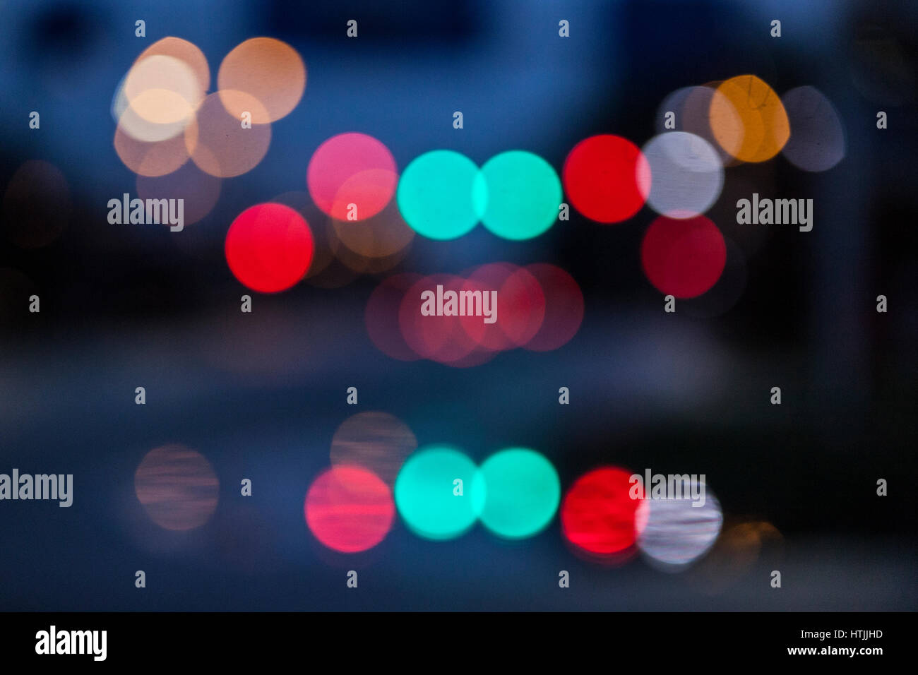 abstract traffic lights in many colors out of focus against black blue ...