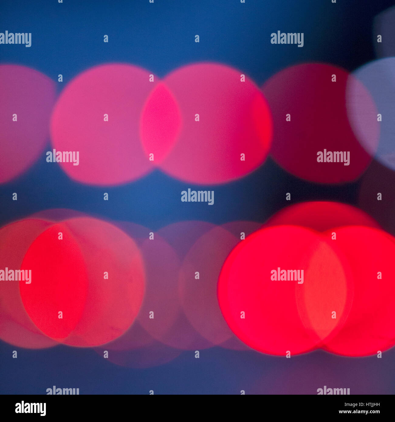 abstract red traffic lights out of focus against black blue background ...