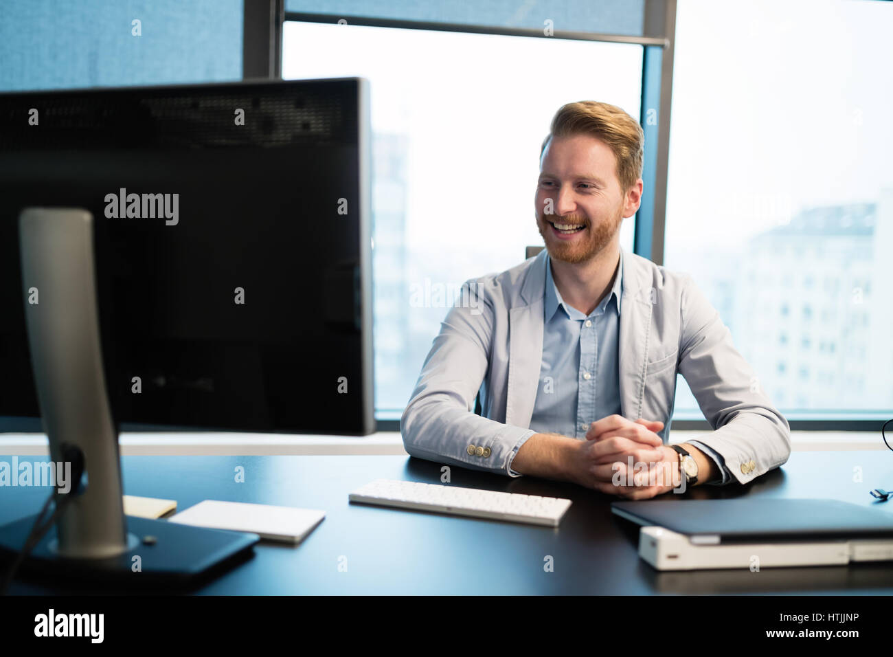 Successful businessman at his working desk in office Stock Photo - Alamy