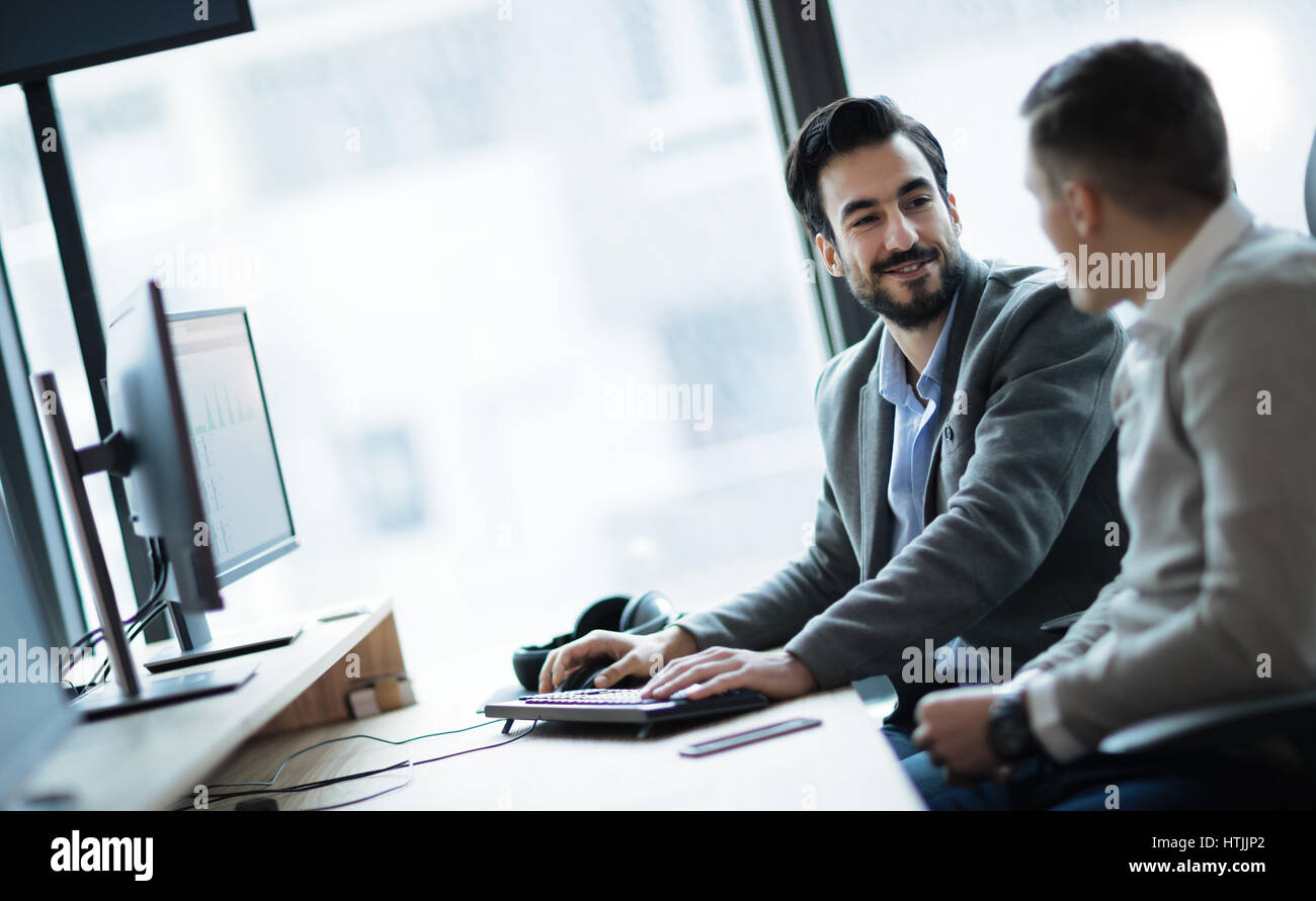 Software engineers developing applications together in office Stock ...