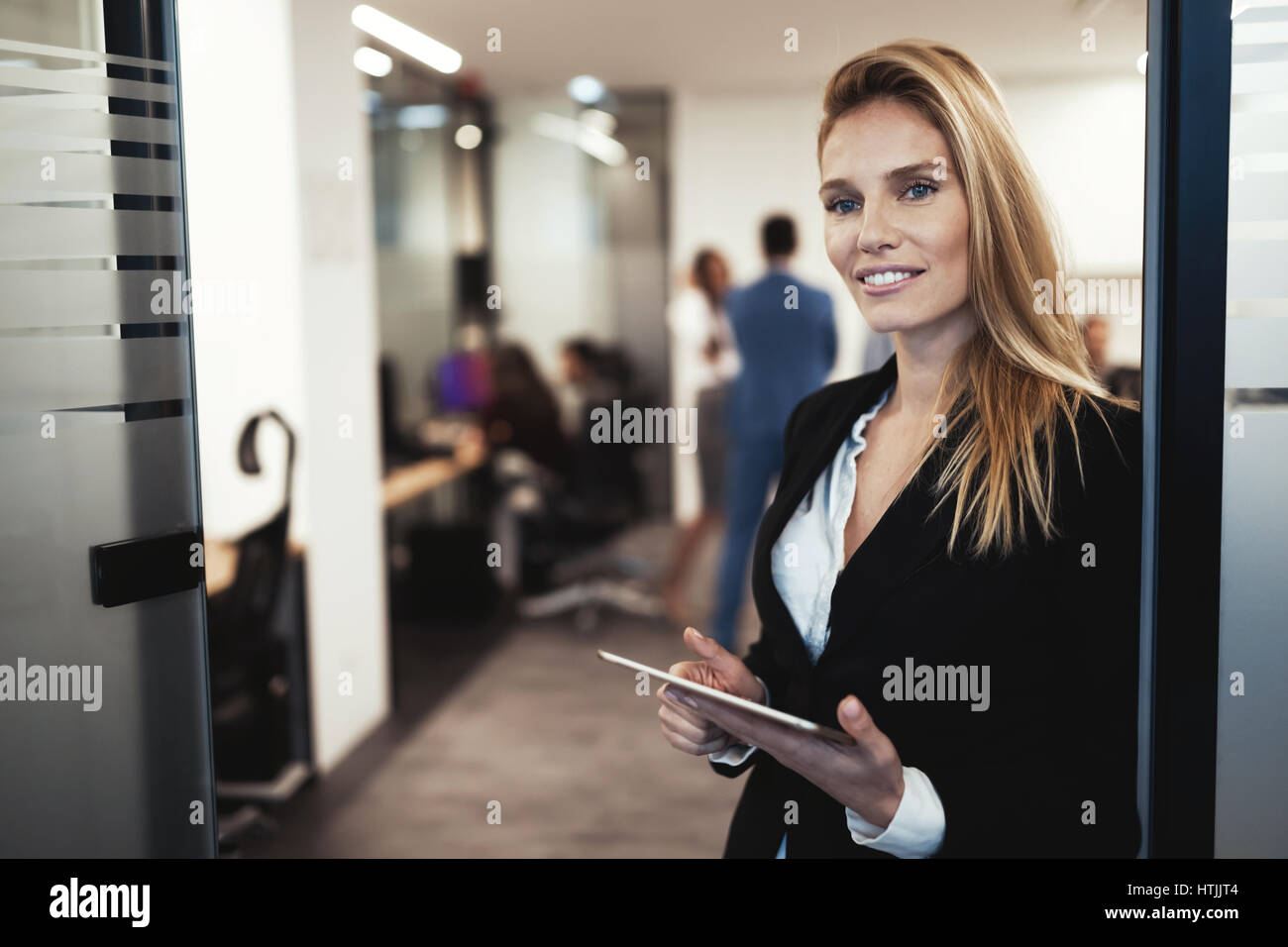 Business woman using tablet at workplace in the office Stock Photo - Alamy