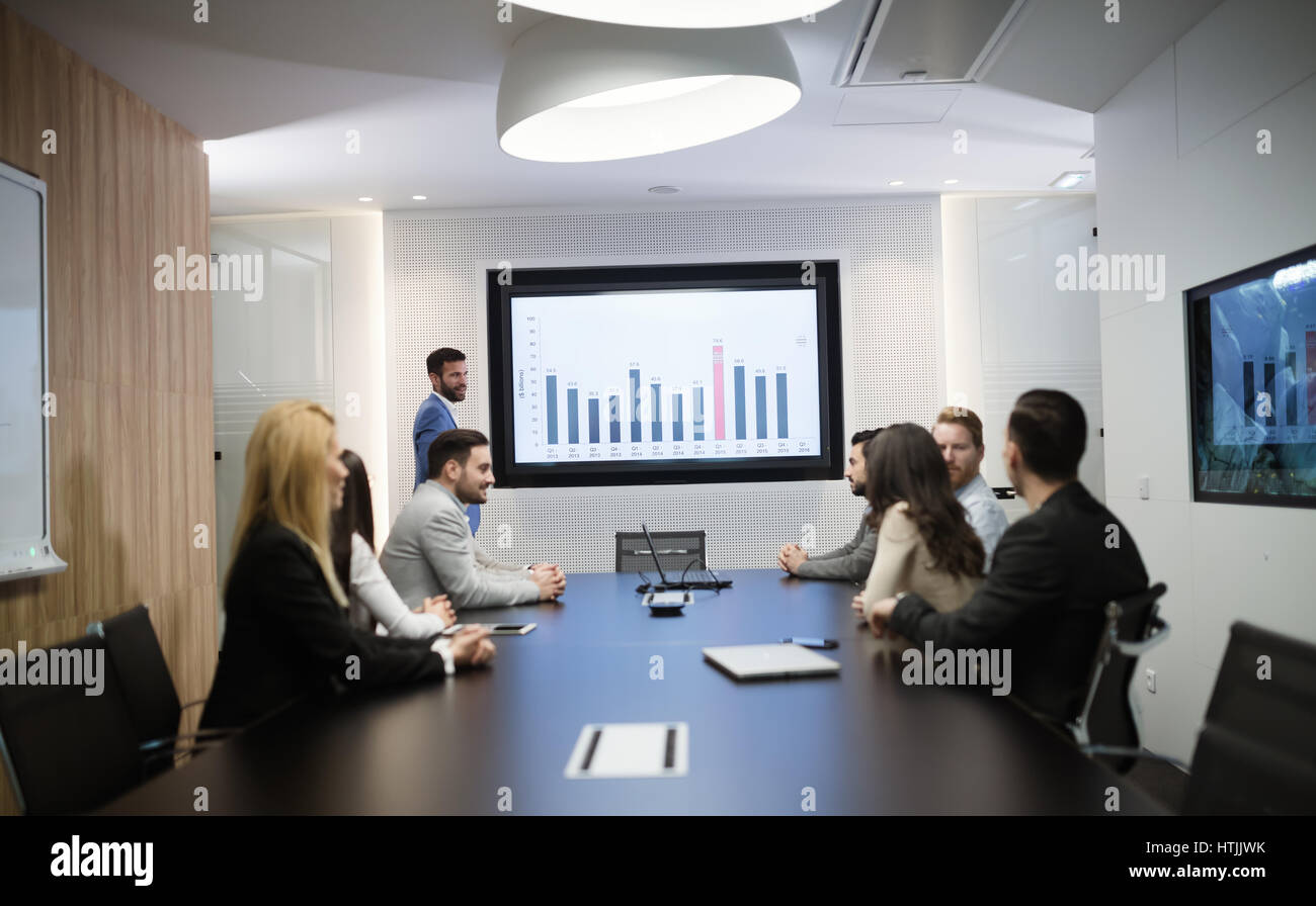 Business colleagues in conference meeting room during presentation ...