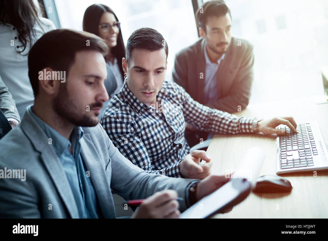 Group of business people and software developers working as a team in ...