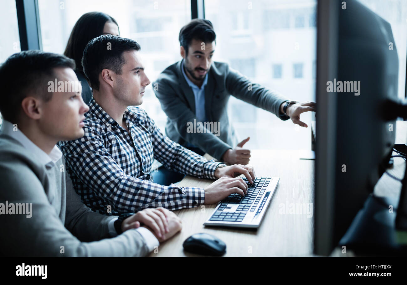 Software engineers developing applications together in office Stock ...