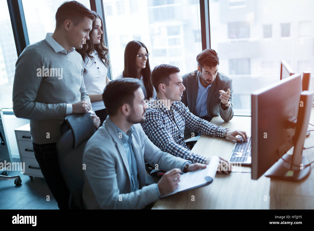 Software engineers developing applications together in office Stock ...