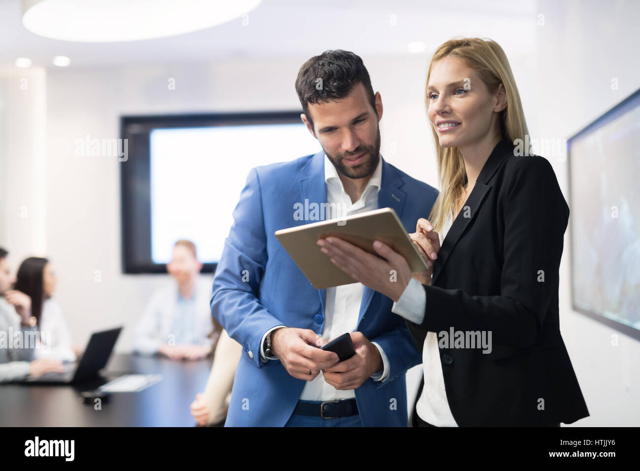 Professional business people at meeting collaborating in office Stock ...