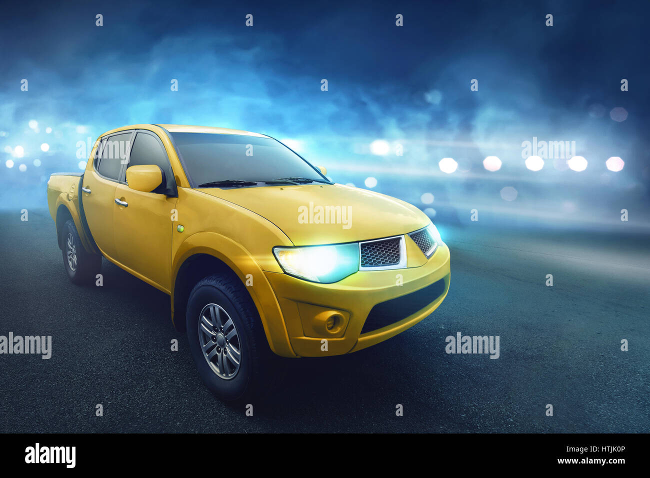 Four door yellow pickup truck with dark concrete on highway Stock Photo ...