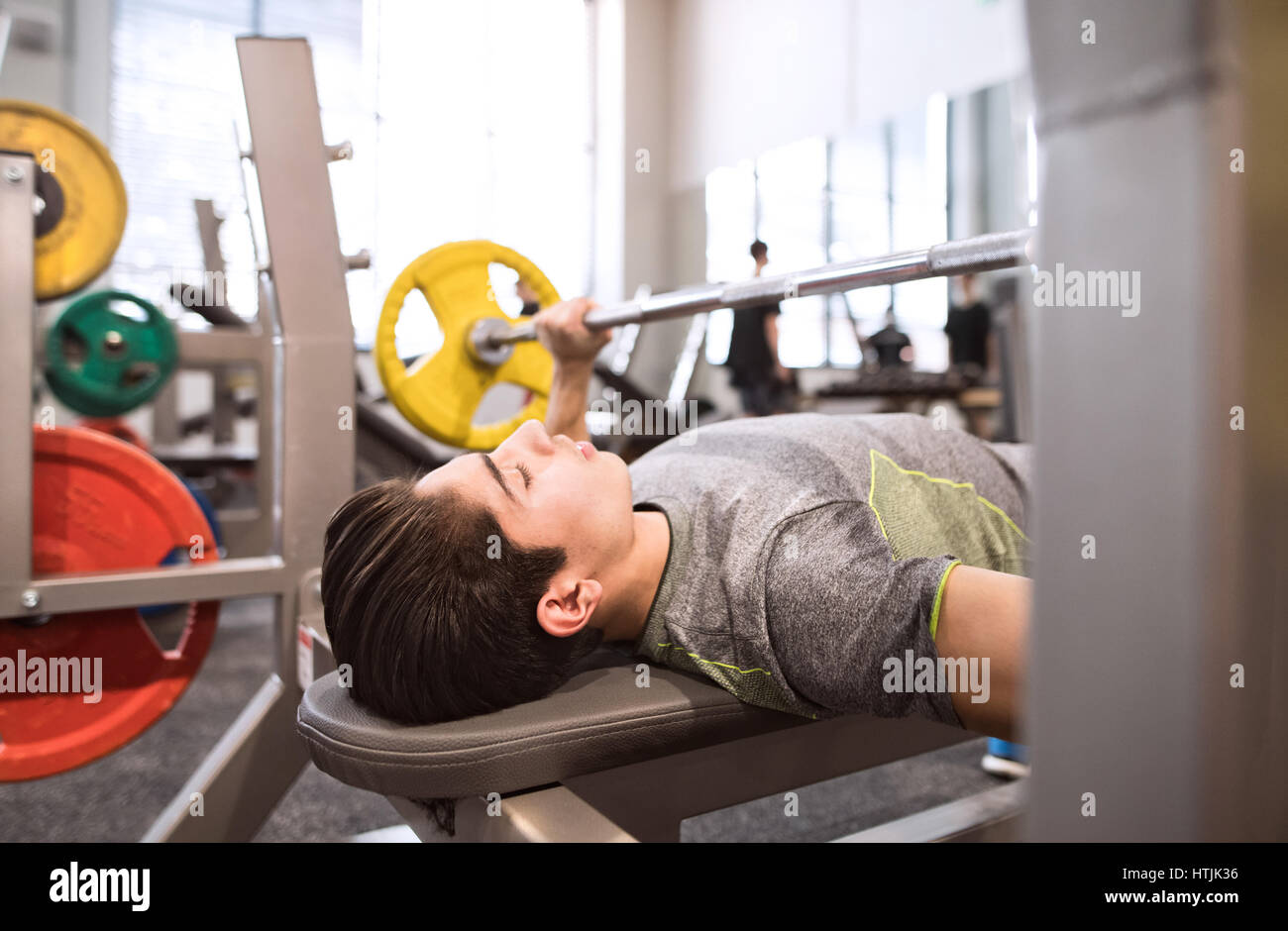 Young hispanic fitness man in gym working out, flexing muscles and ...